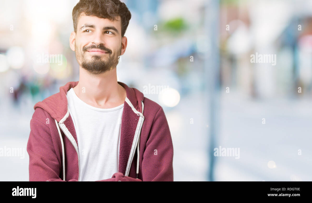 Young handsome man over isolated background smiling looking side and ...