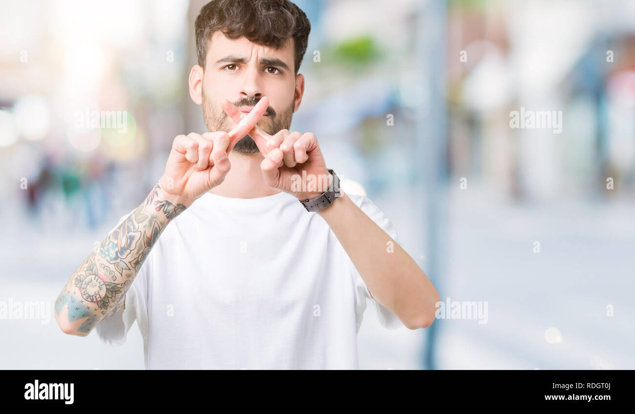Young handsome man wearing white t-shirt over isolated background ...