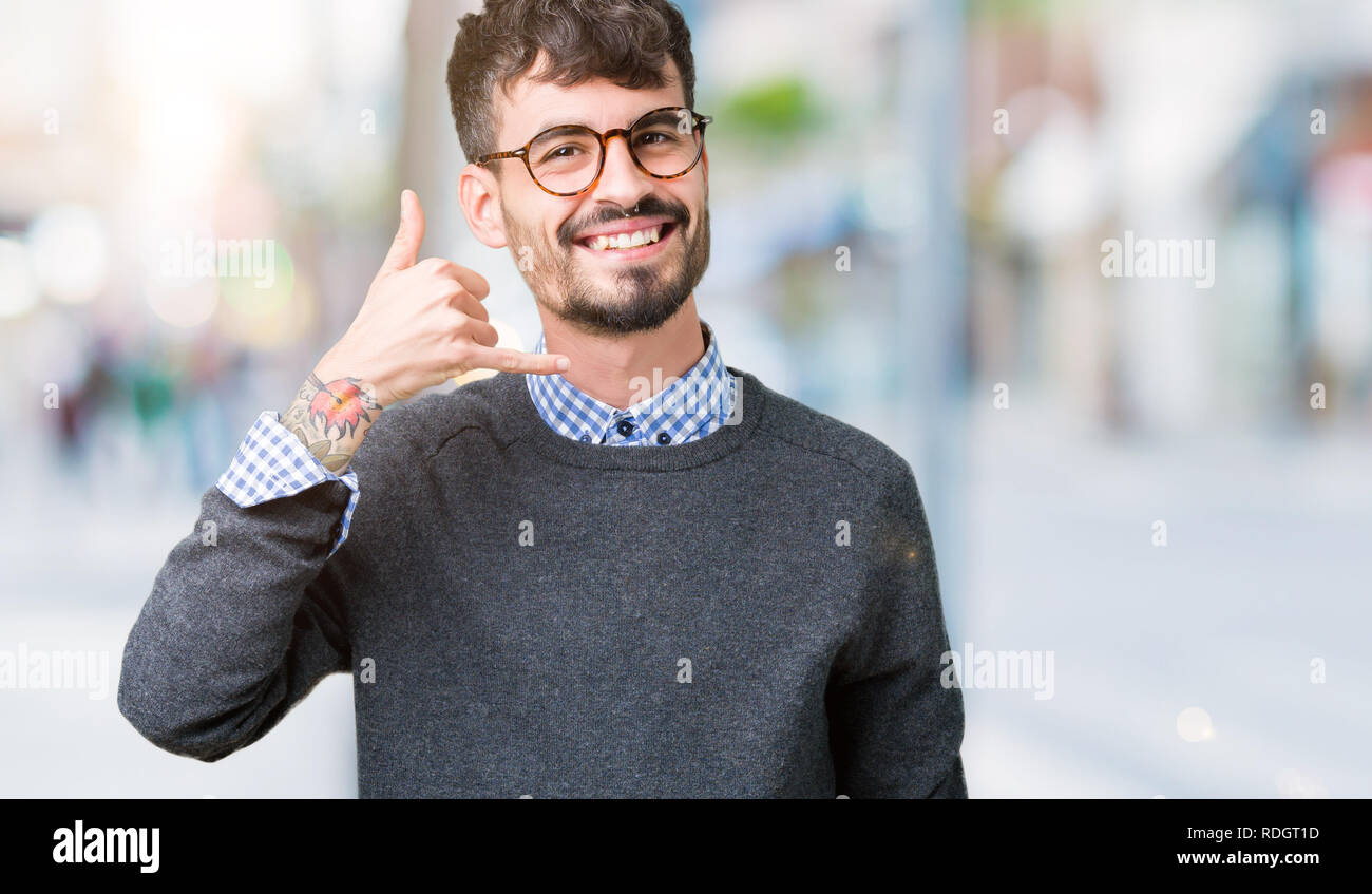 Young handsome smart man wearing glasses over isolated background ...