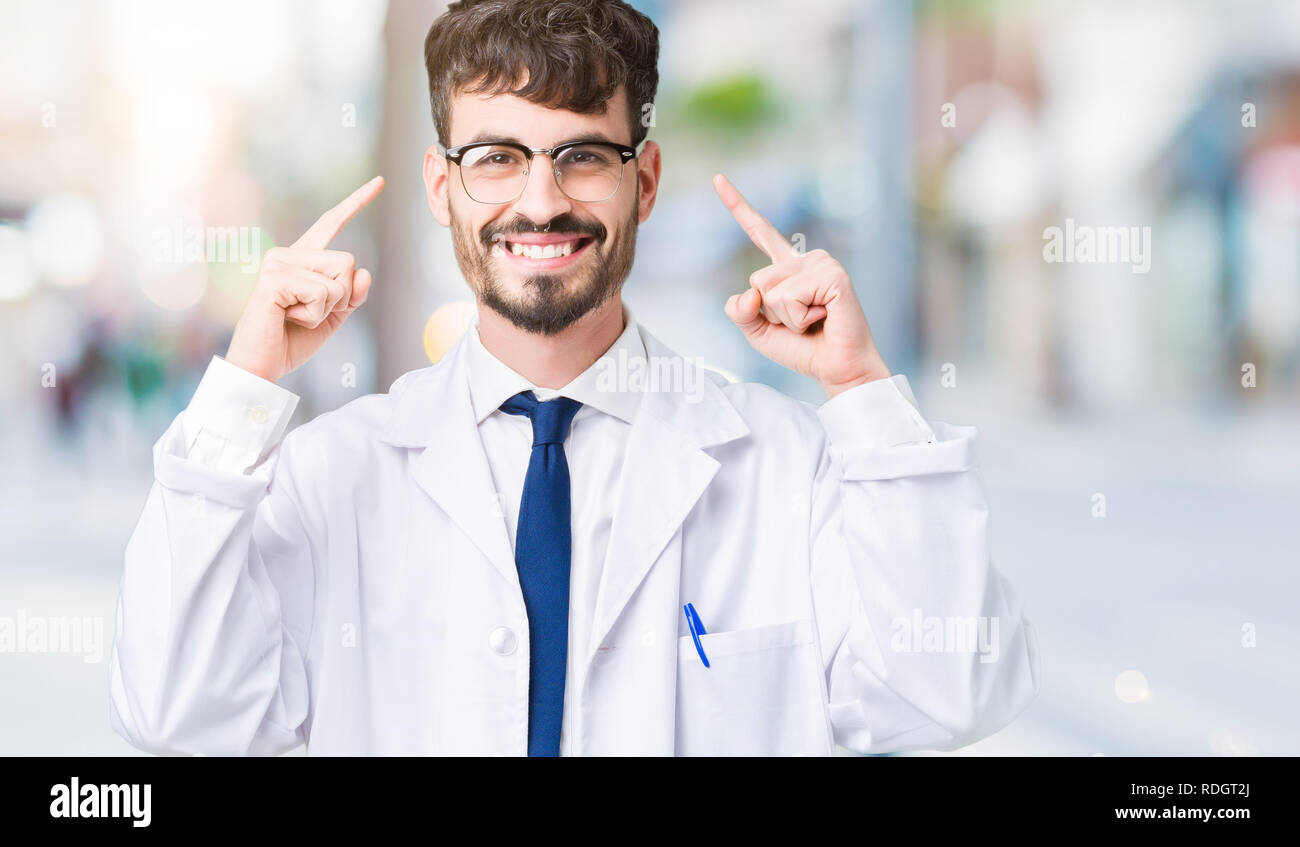 Young professional scientist man wearing white coat over isolated ...
