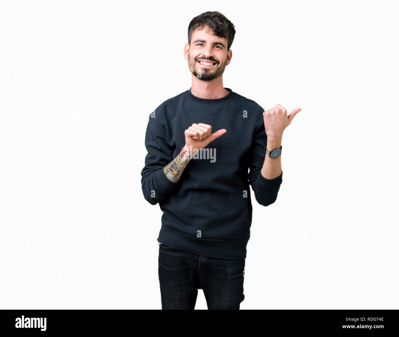 Young handsome man over isolated background Pointing to the back behind ...