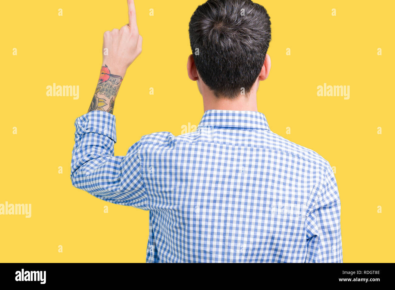 Young handsome business man over isolated background Posing backwards ...