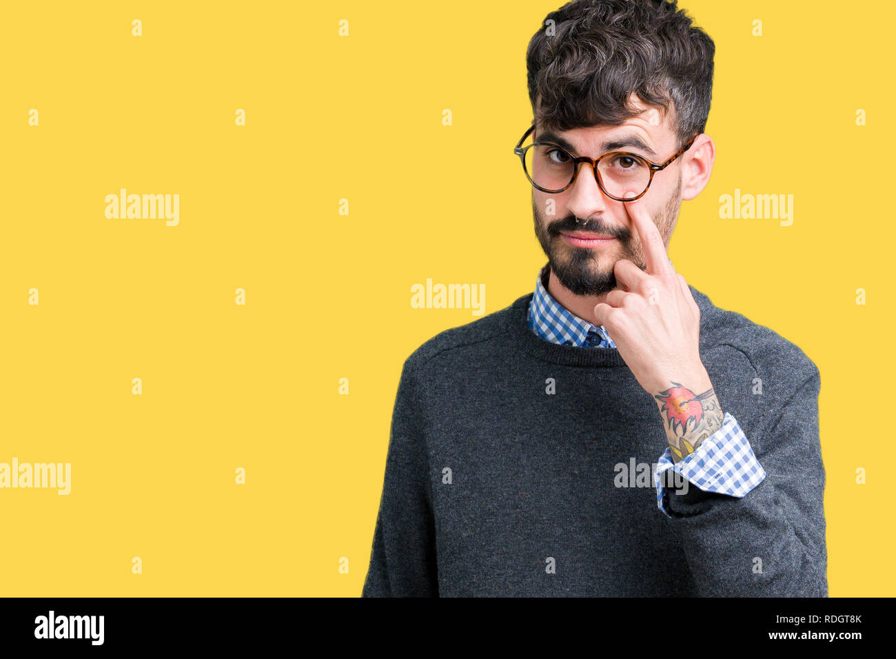 Young handsome smart man wearing glasses over isolated background ...