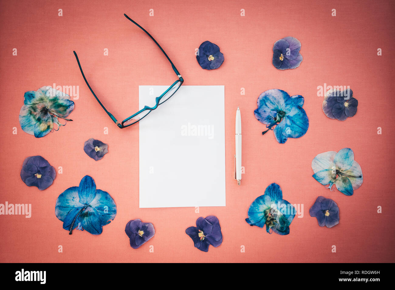 Creative writing concept. Blank sheet of paper, pen, glasses and blue ...