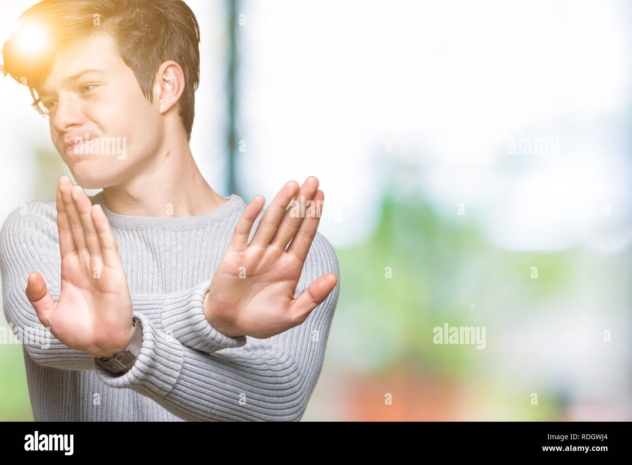 Young handsome man wearing winter sweater over isolated background ...