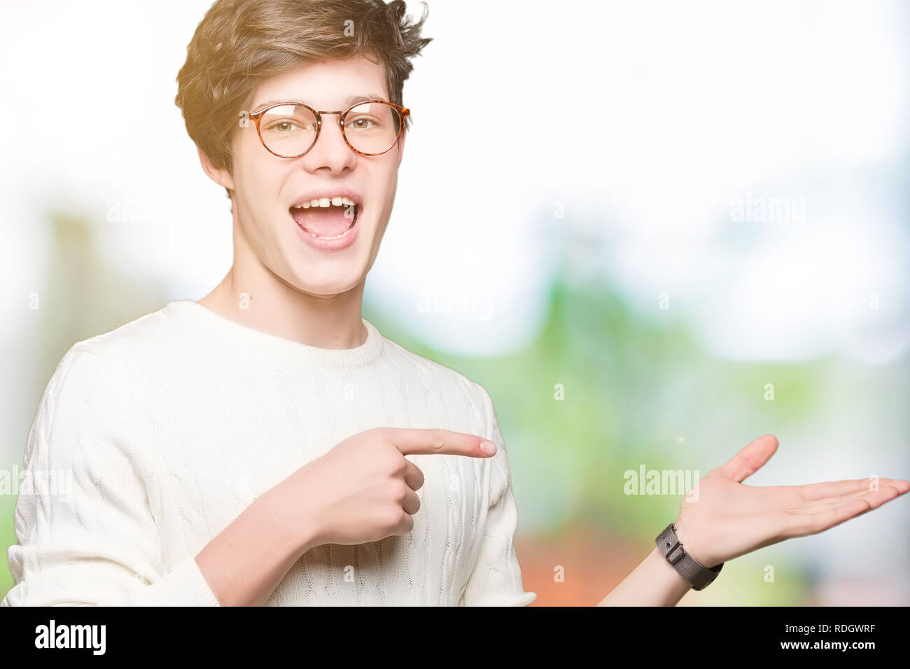 Young handsome man wearing glasses over isolated background amazed and ...