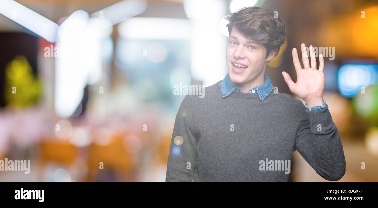 Young handsome elegant man over isolated background Waiving saying ...