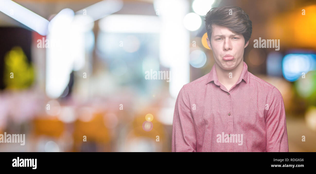 Young handsome business man over isolated background depressed and ...
