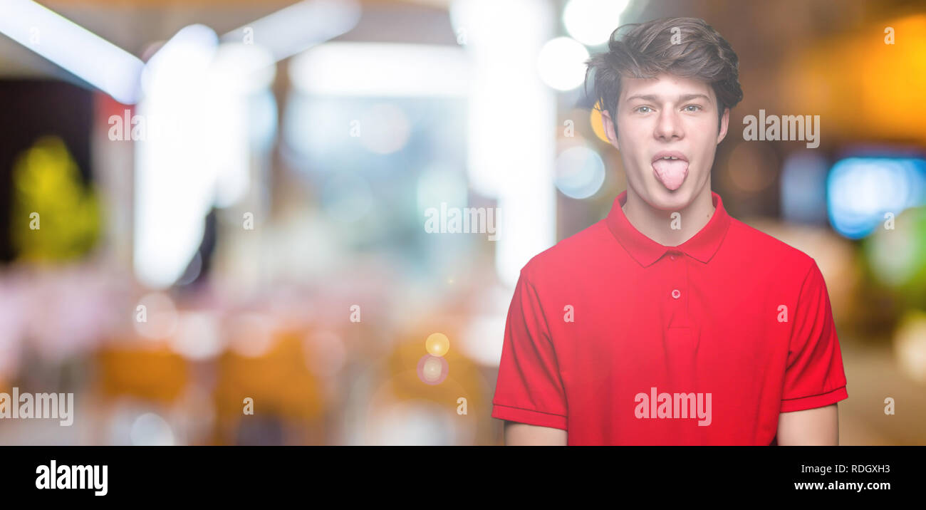 Young handsome man wearing red t-shirt over isolated background ...
