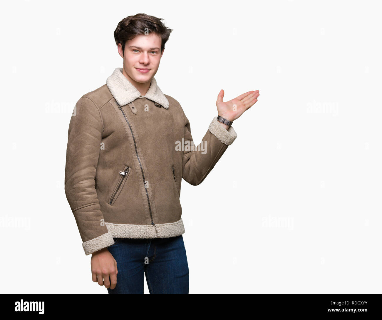 Young handsome man wearing winter coat over isolated background smiling ...