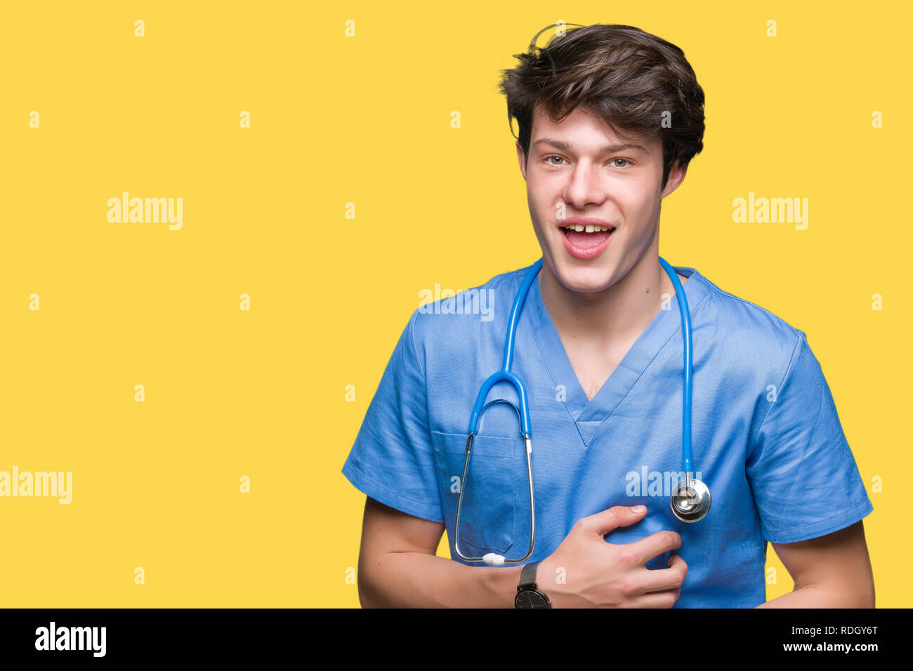 Young doctor wearing medical uniform over isolated background Smiling ...