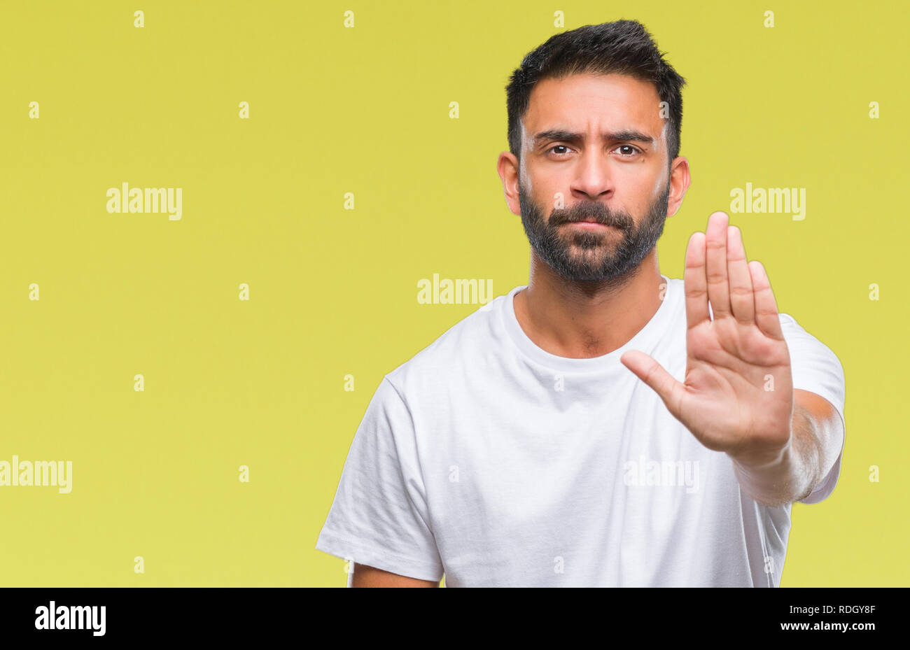 Adult hispanic man over isolated background doing stop sing with palm ...