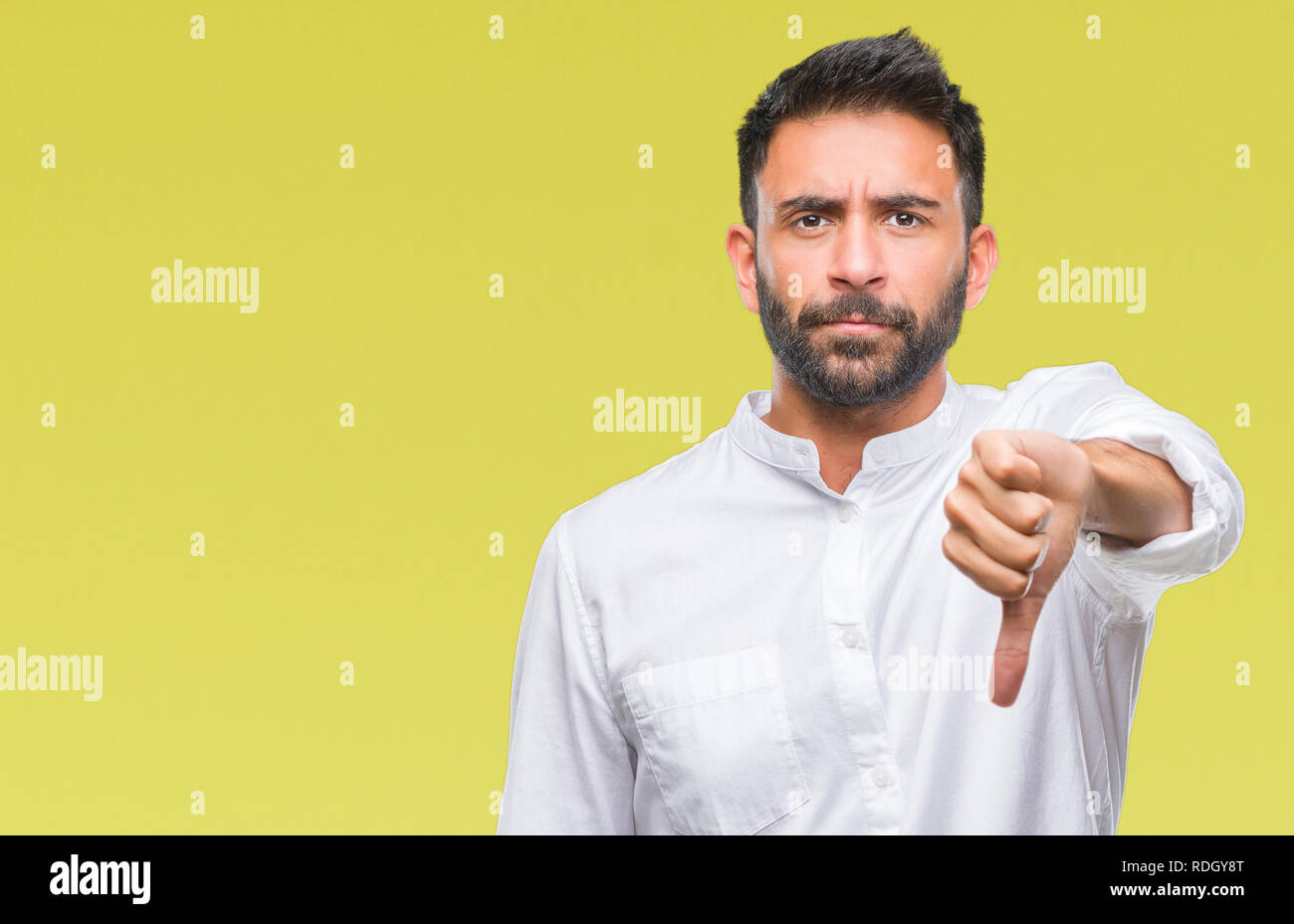 Adult hispanic man over isolated background looking unhappy and angry ...
