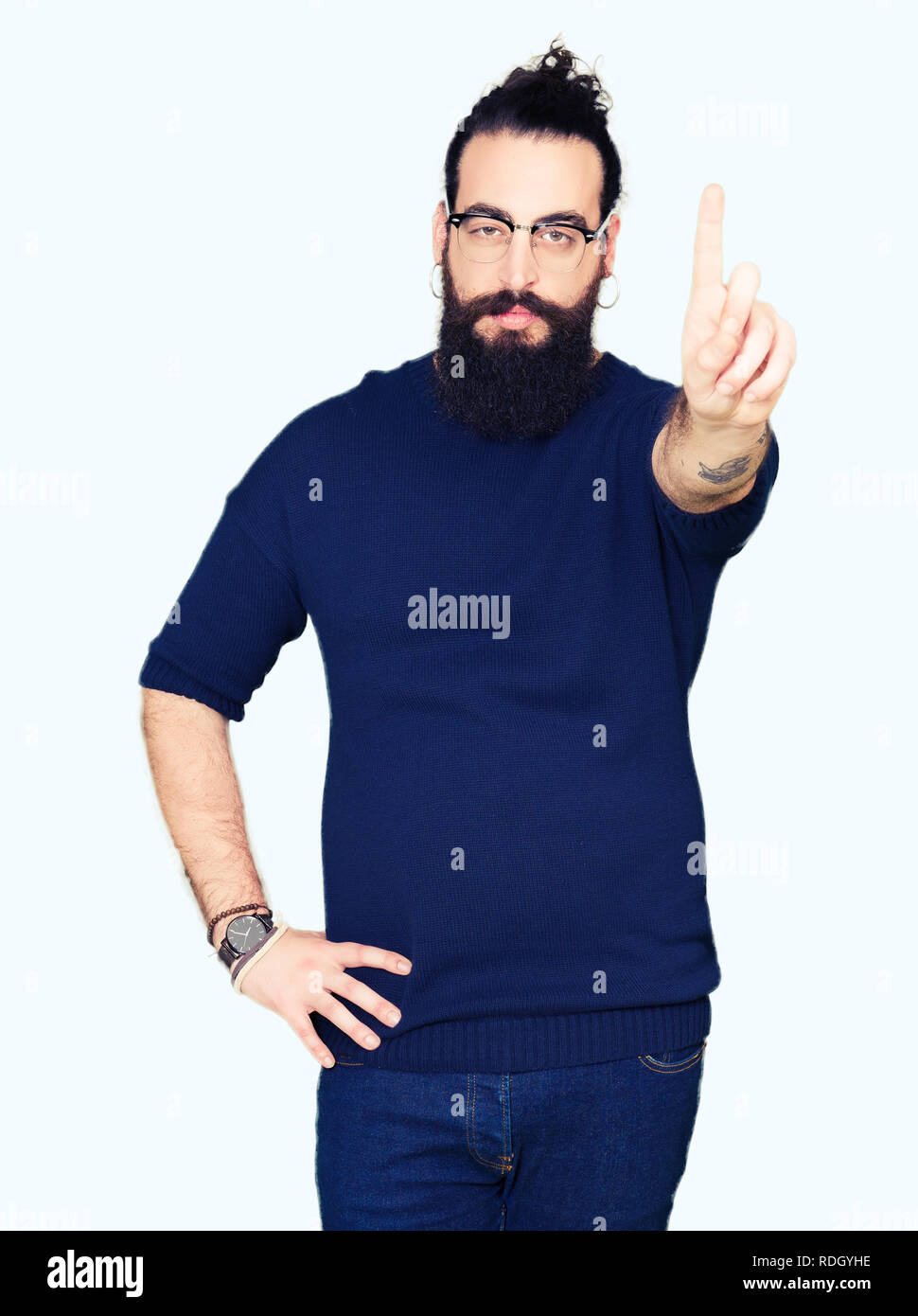 Young hipster man with long hair and beard wearing glasses Pointing ...