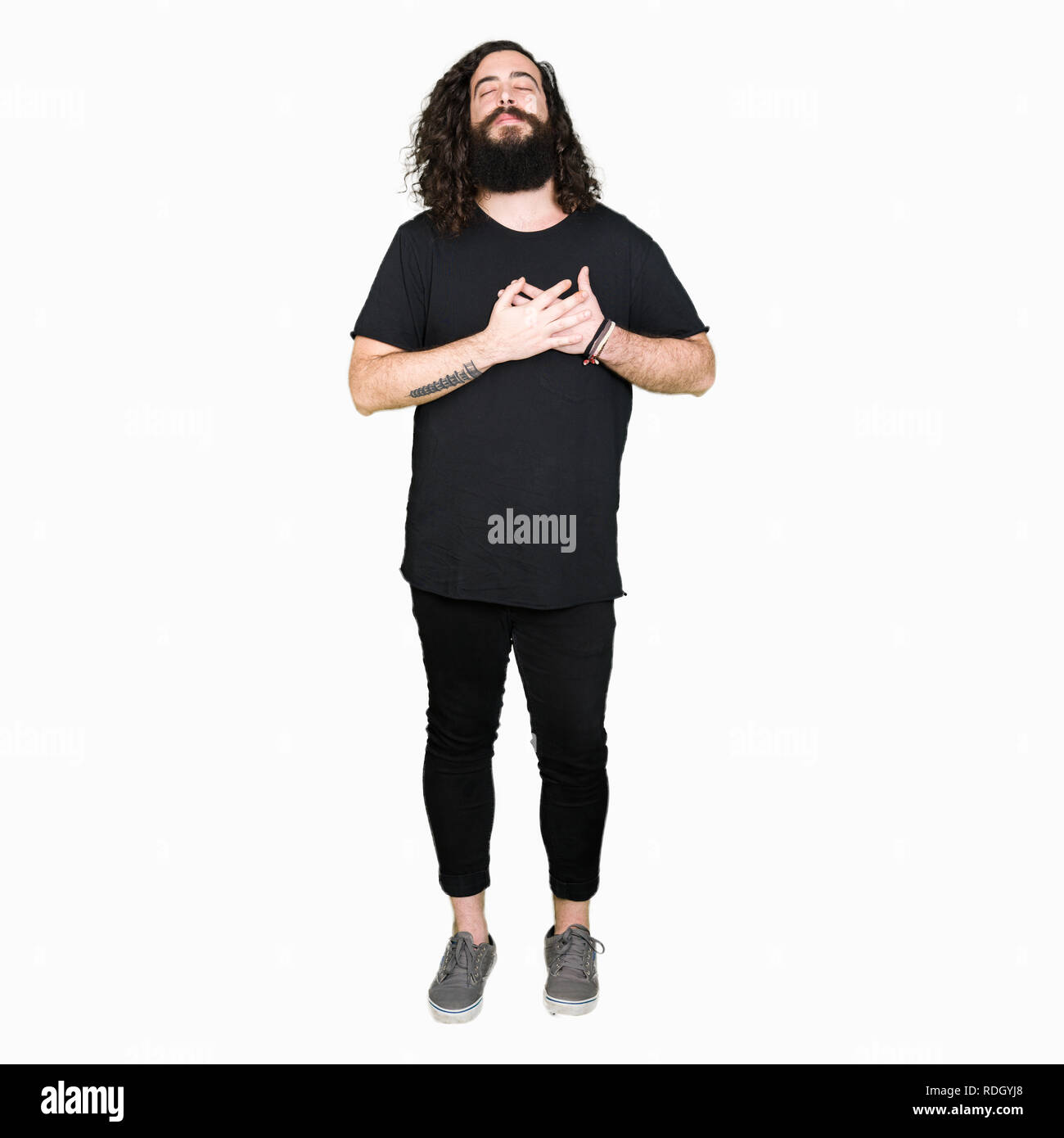 Young man with long hair and beard wearing heavy metal black outfit ...