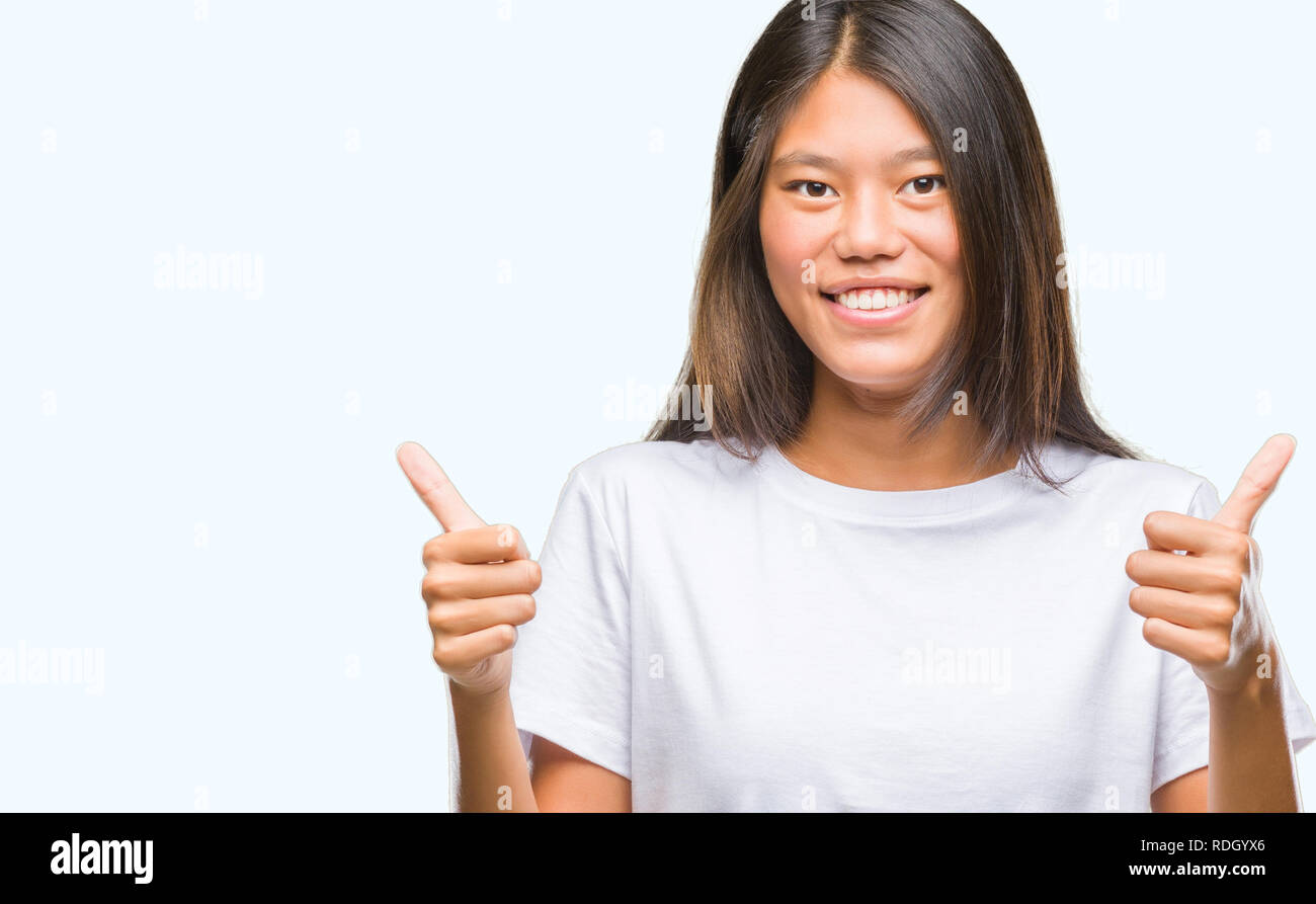 Young asian woman over isolated background success sign doing positive ...