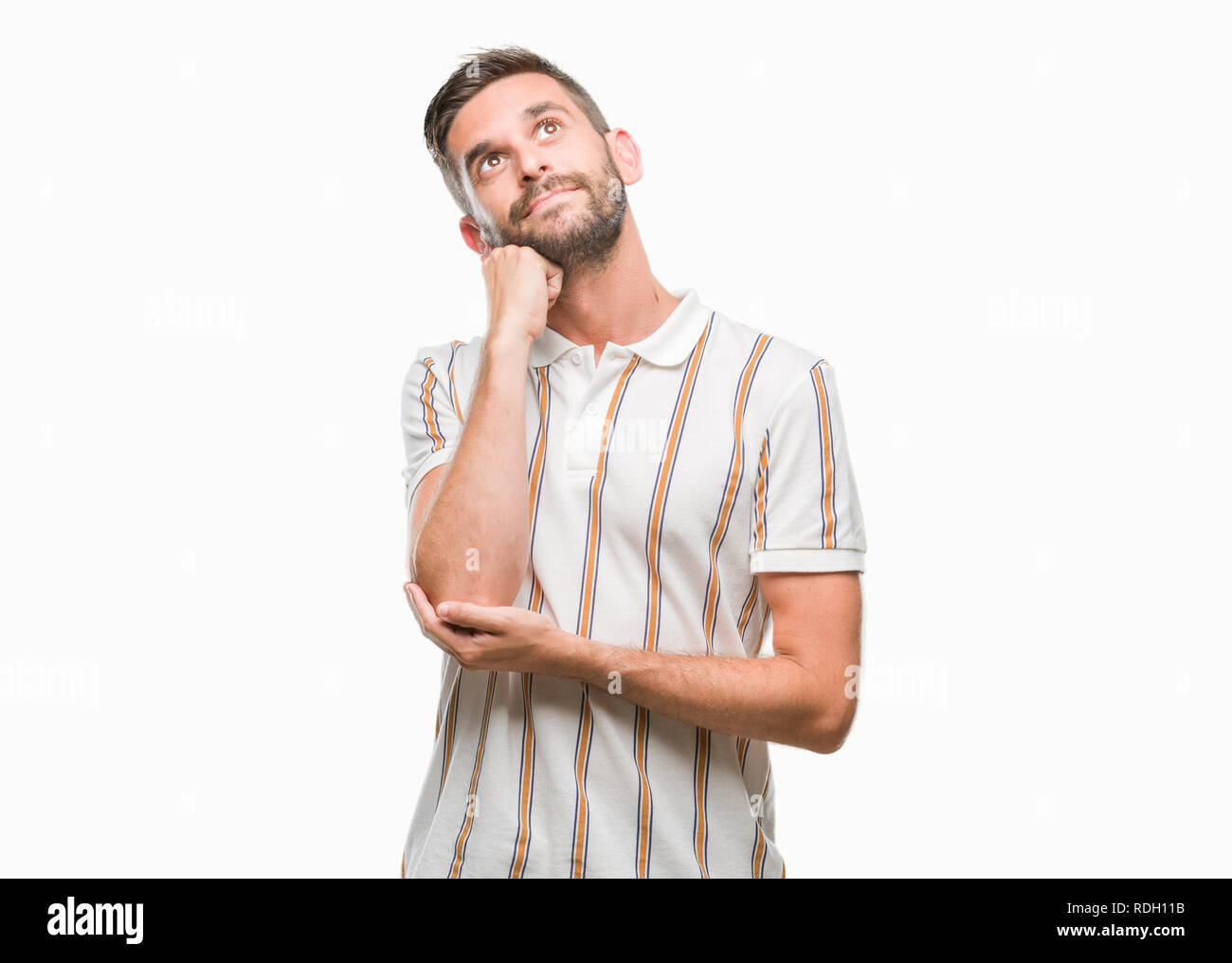 Young handsome man over isolated background with hand on chin thinking ...