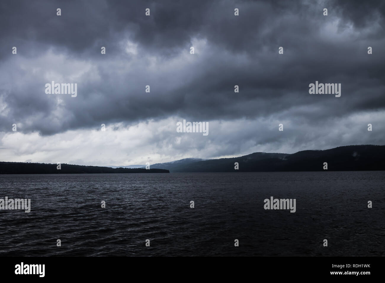 Dark clouds clearing over hills Stock Photo - Alamy
