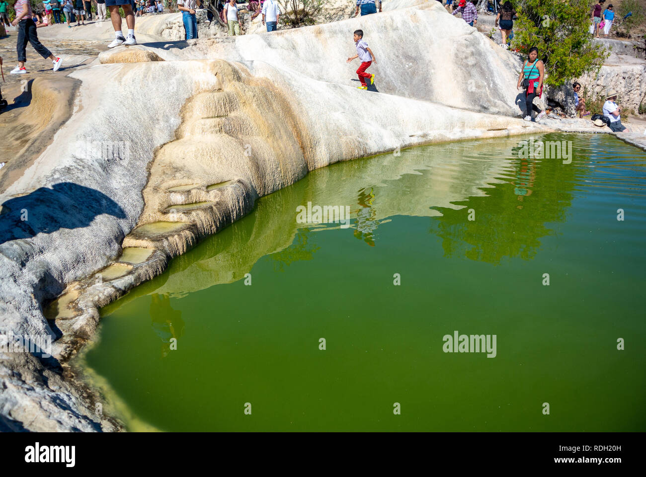 Tourists by a lake done by petrified waterfall, Hierve el Agua, Oaxaca ...