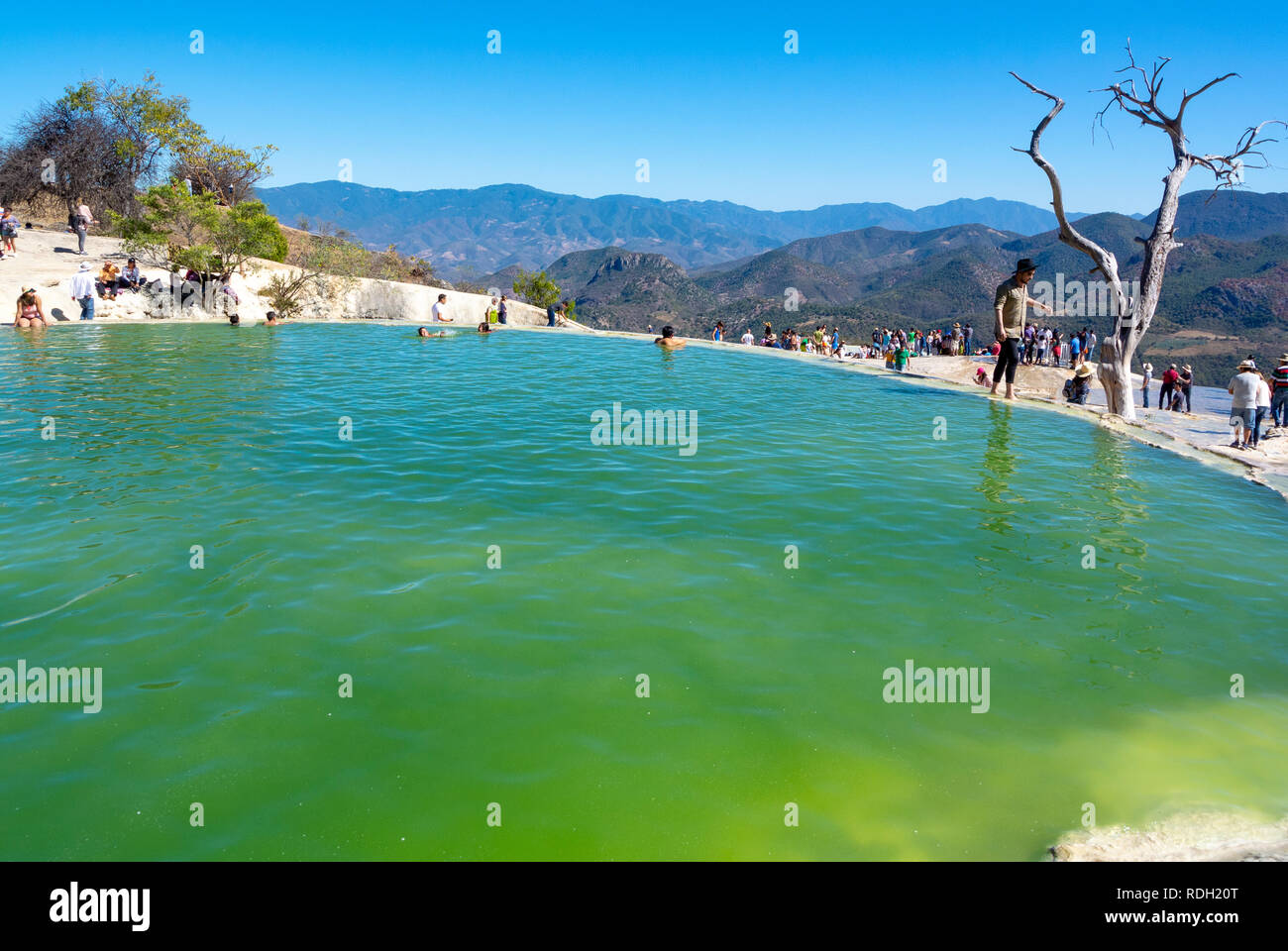 Tourists at a lake done by petrified waterfall, Hierve el Agua, Oaxaca ...