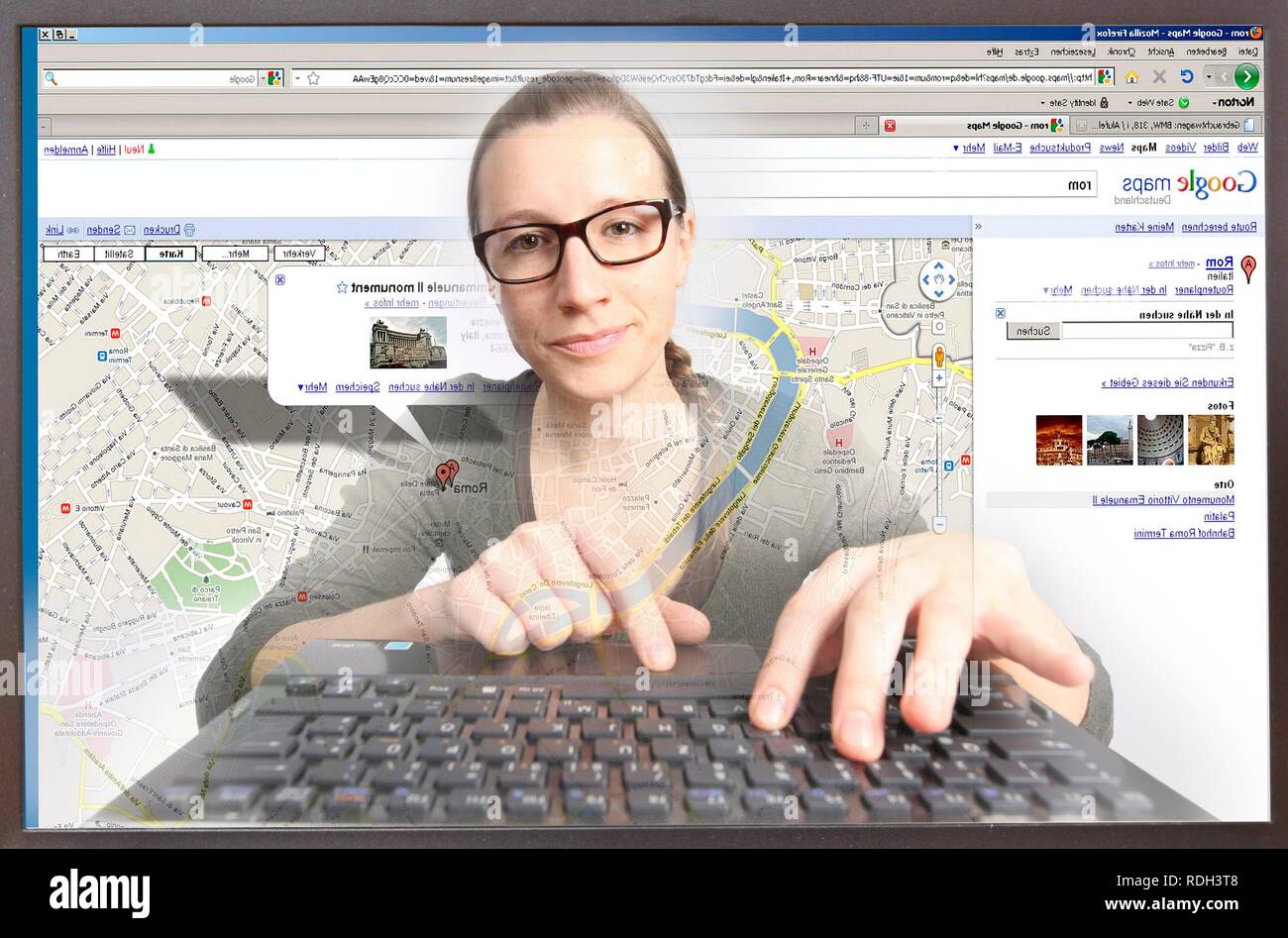 Young woman sitting at a computer surfing the Internet, viewing a page ...