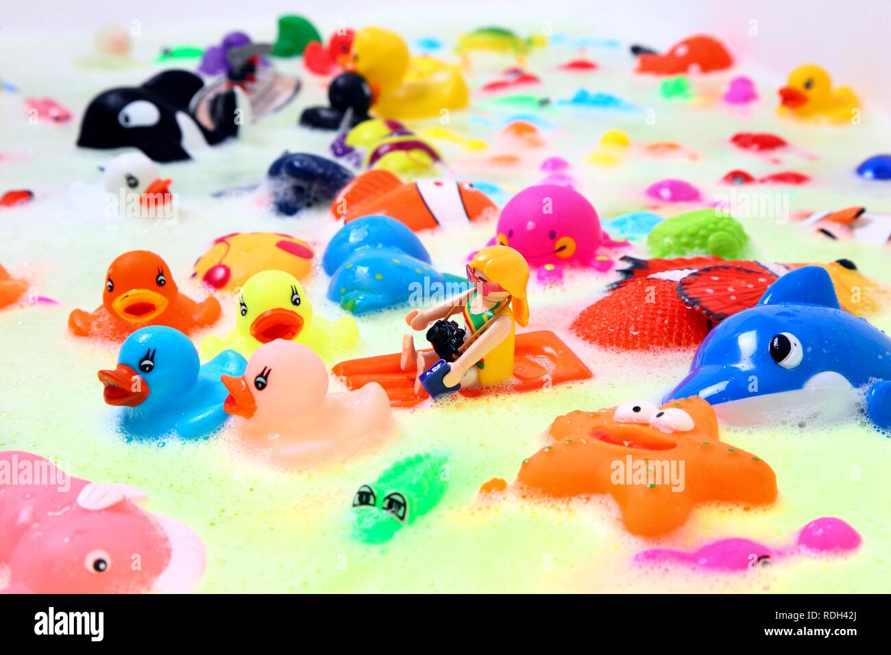 Various colourful water toys with bath foam Stock Photo - Alamy