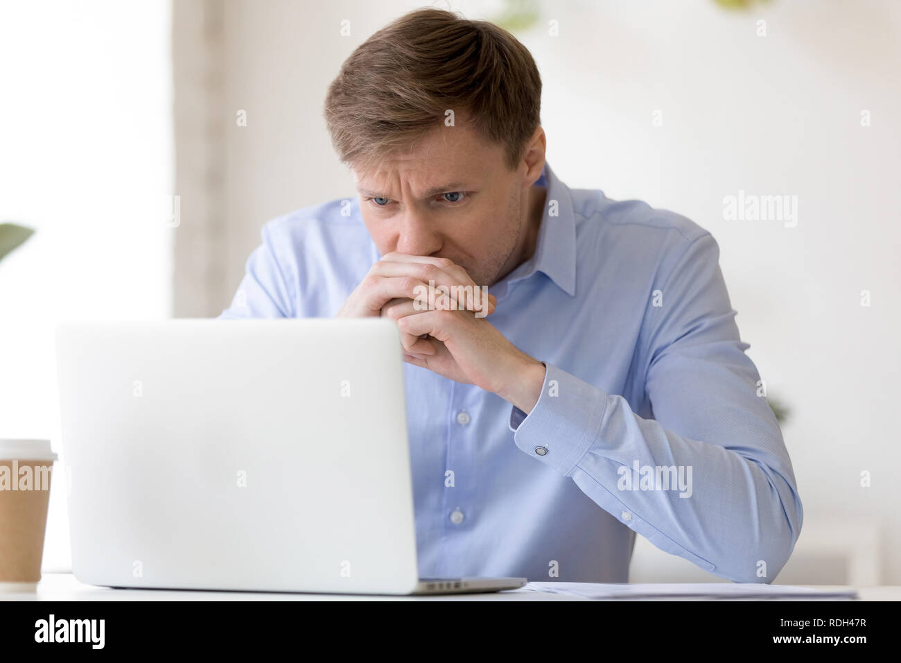 Focused businessman looking at laptop screen, thinking about bus Stock ...