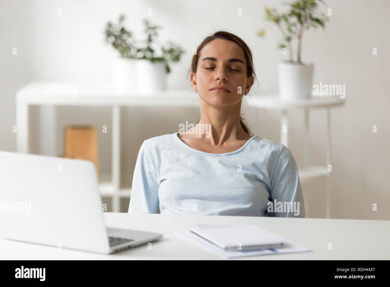 Calm attractive woman relaxing at workplace with closed eyes Stock ...
