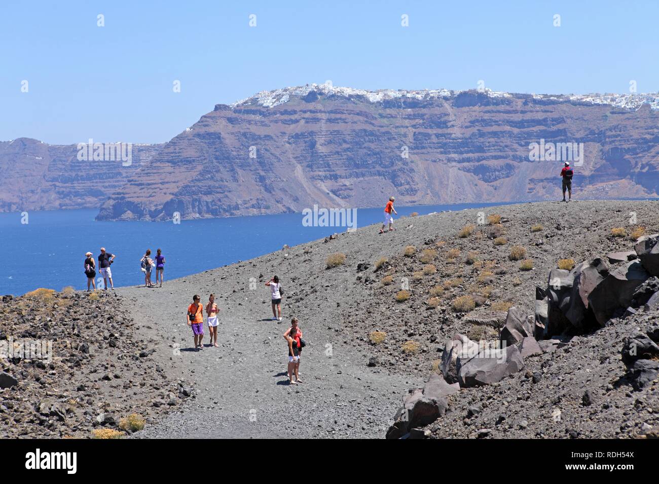 Climbing the volcano, volcanic island Nea Kameni, in the back Thira ...