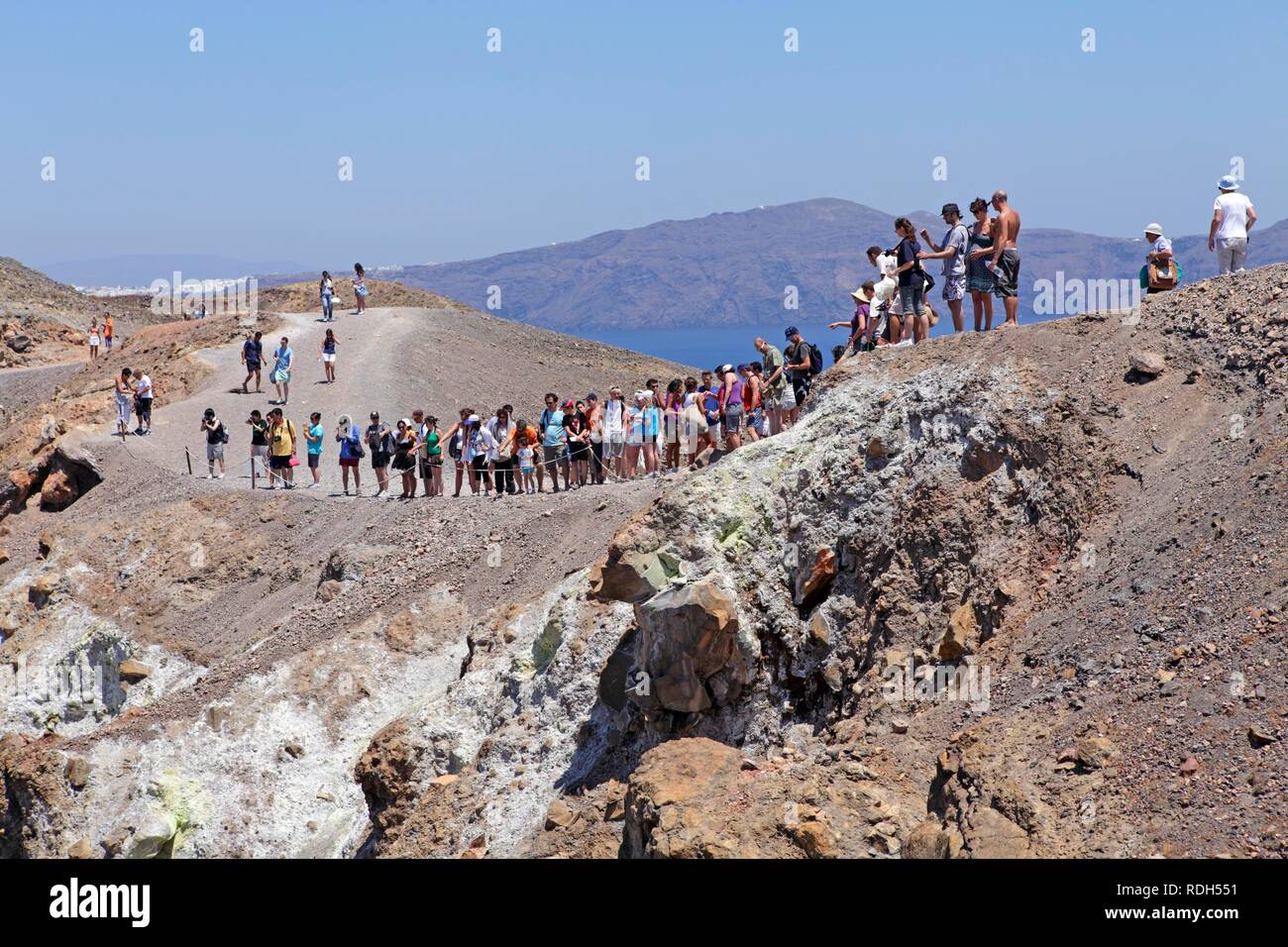 Climbing the volcano, volcanic island Nea Kameni, in the back Thira ...