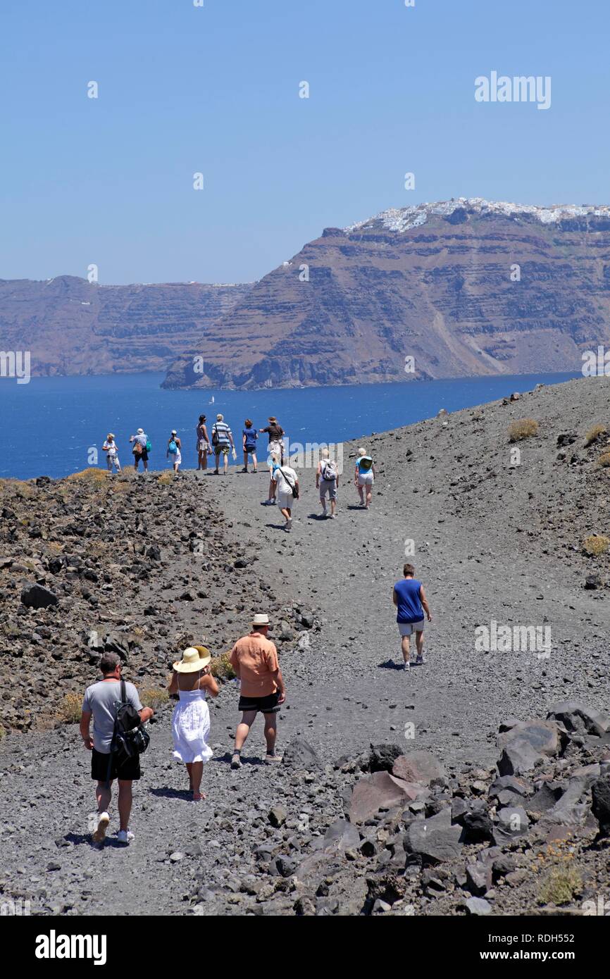 Climbing the volcano, volcanic island Nea Kameni, in the back Thira ...