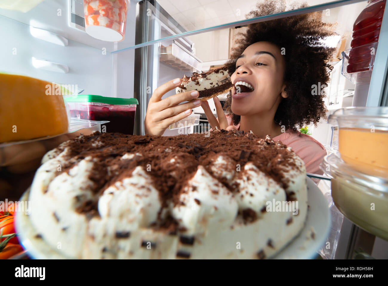 Woman eating cake black hi-res stock photography and images - Alamy