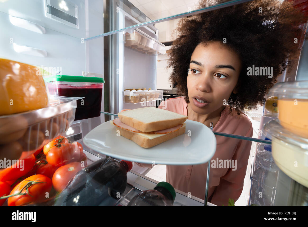 Close-up Of A African Young Woman Searching For Food In An Open ...