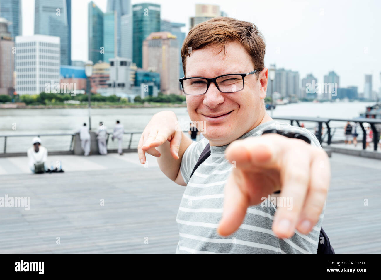 happy and expressive elegant gentleman pointing the camera with smile ...