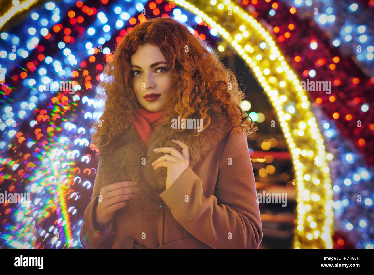Young attractive red-haired girl. Portrait on the night street of the ...