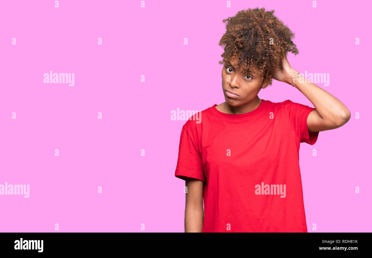 Beautiful young african american woman over isolated background confuse ...