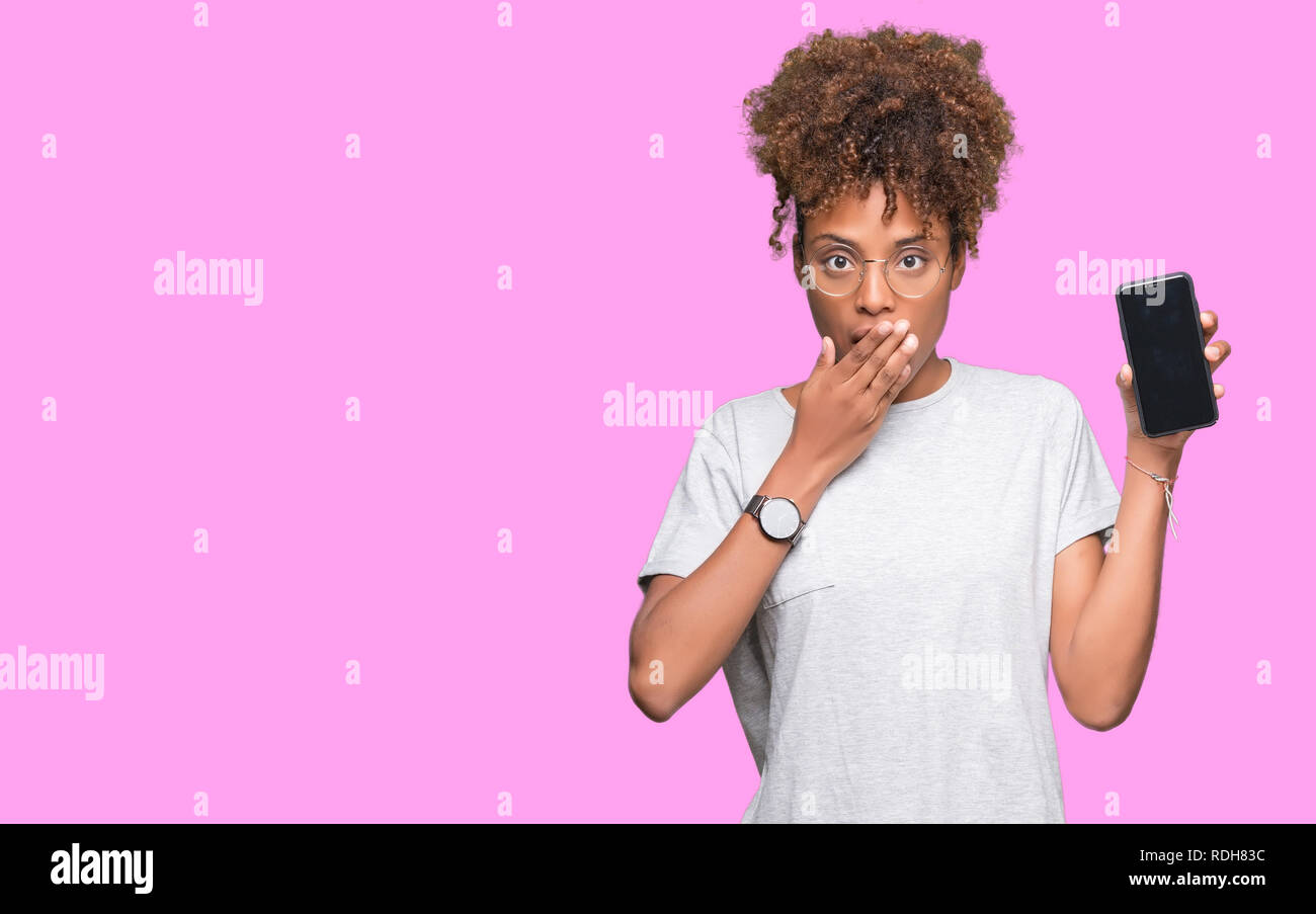 Young african american woman showing smartphone screen over isolated ...