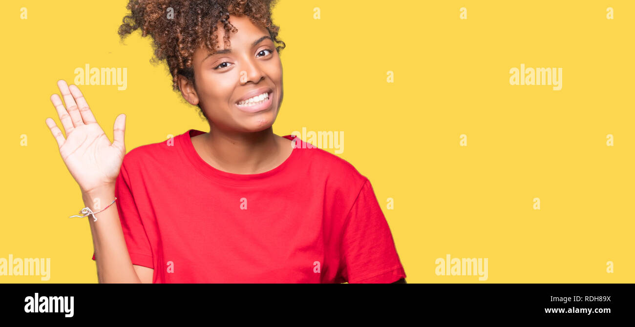 Beautiful young african american woman over isolated background Waiving ...