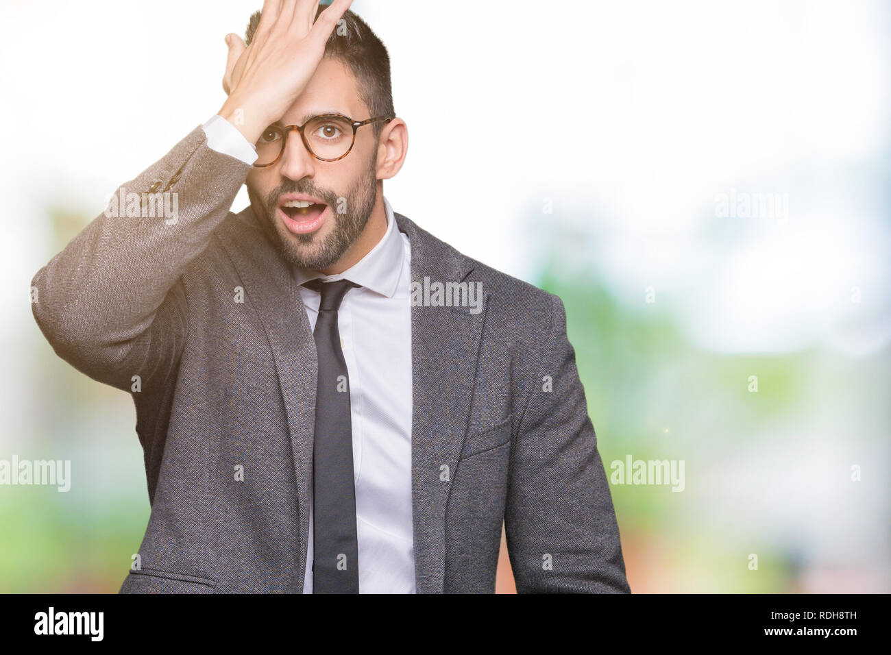 Young handsome business man over isolated background surprised with ...