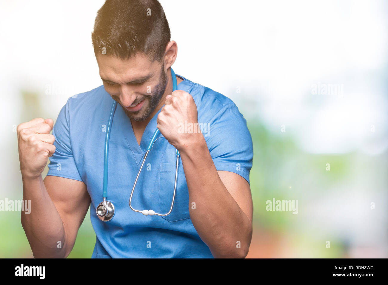Handsome young doctor surgeon man over isolated background very happy ...