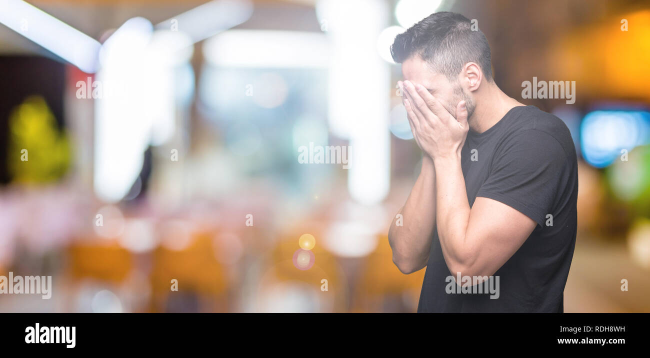 Young handsome man over isolated background with sad expression ...