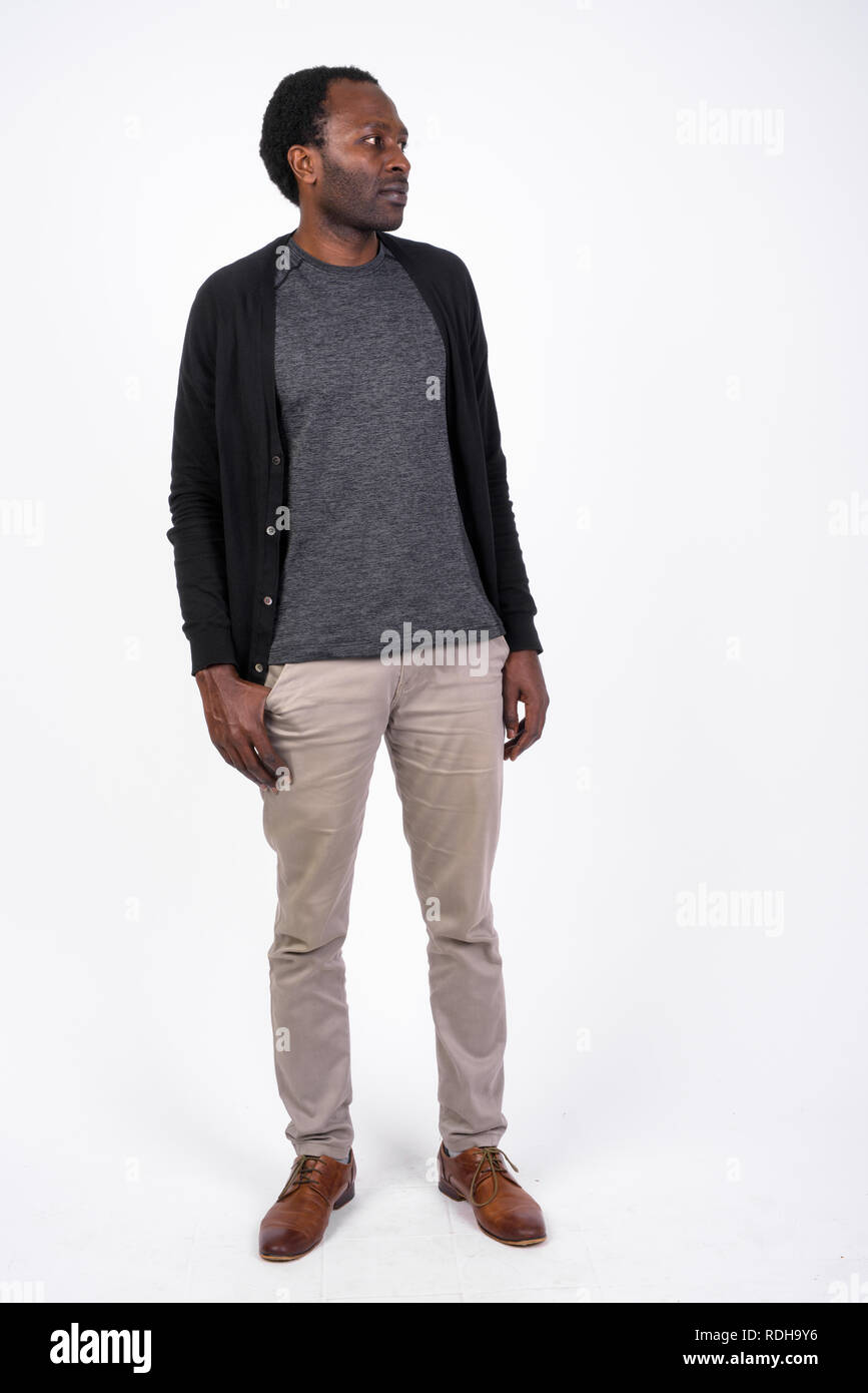 Full body shot of handsome African man thinking Stock Photo - Alamy