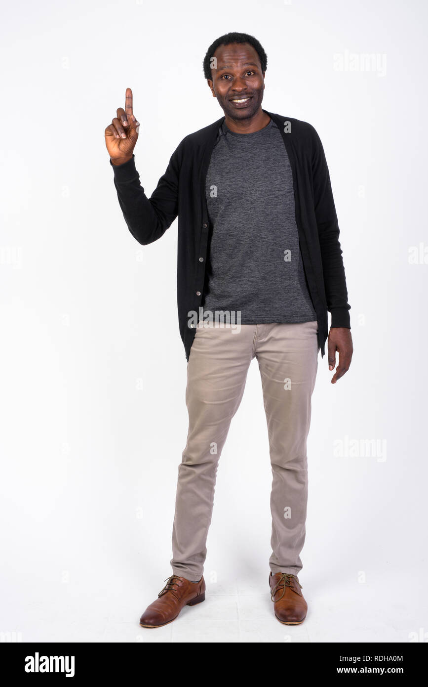 Full body shot of happy African man pointing finger up Stock Photo - Alamy