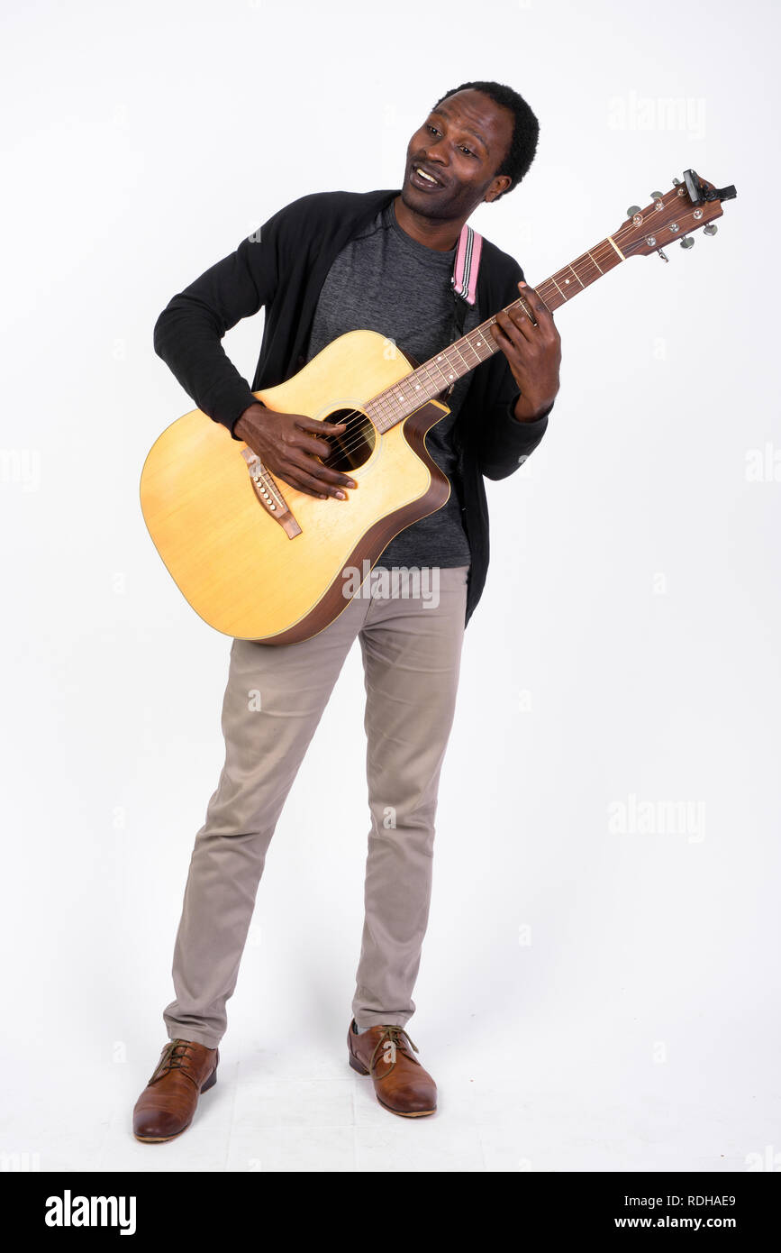 Full body shot of handsome African man playing the guitar Stock Photo ...