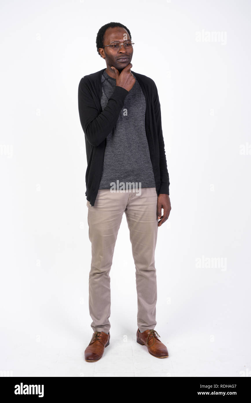 Full body shot of serious African man thinking Stock Photo - Alamy