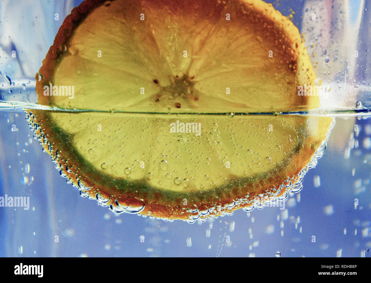 Lemon slice in water Stock Photo - Alamy