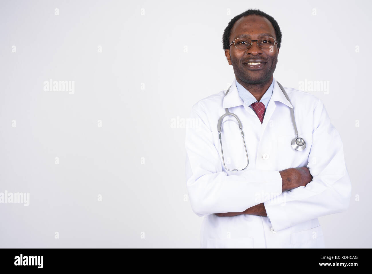 Portrait of happy African man doctor smiling with arms crossed Stock ...