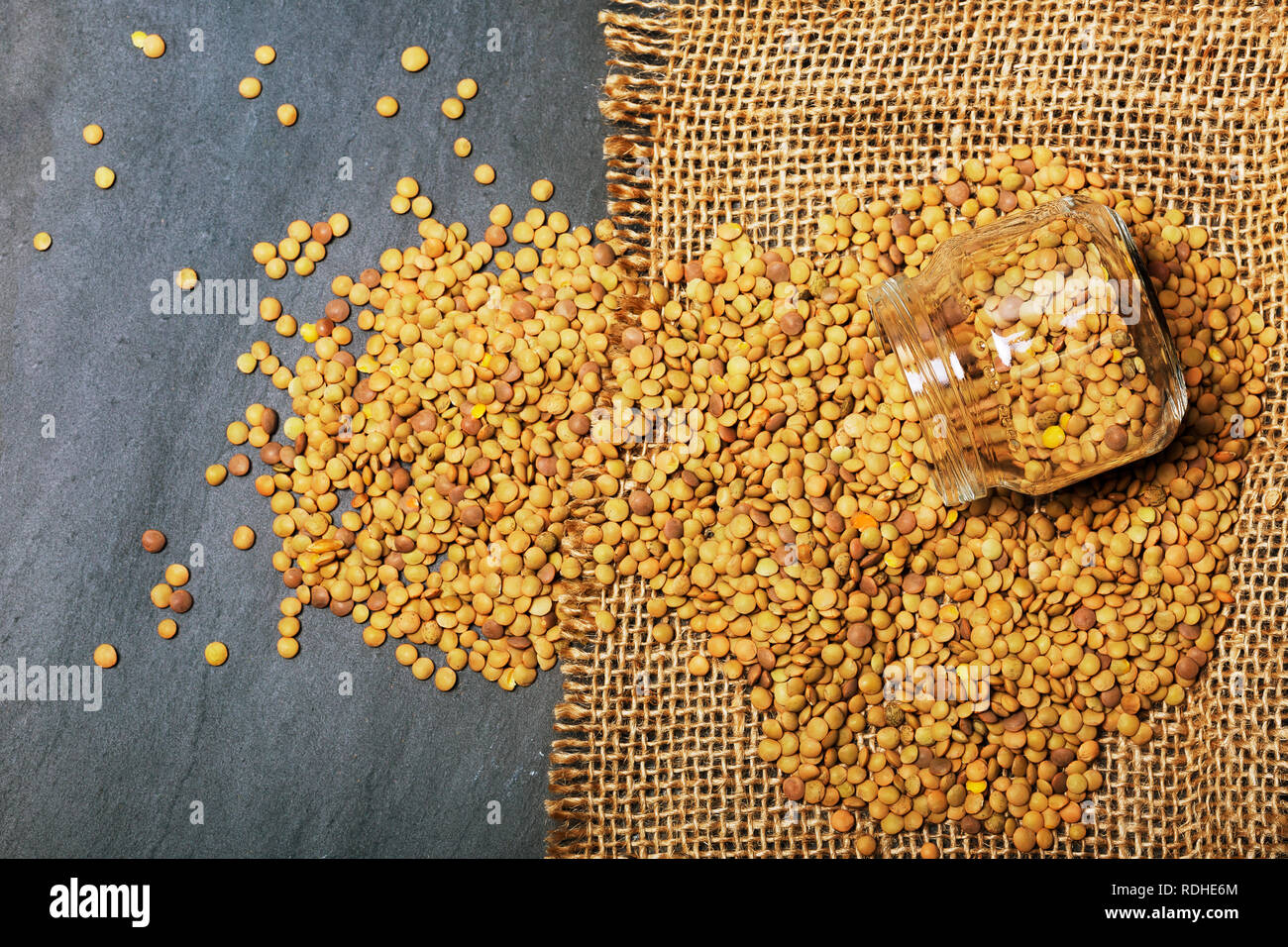 Raw lentils on balck stone background. Healthy vegetarian food concept ...