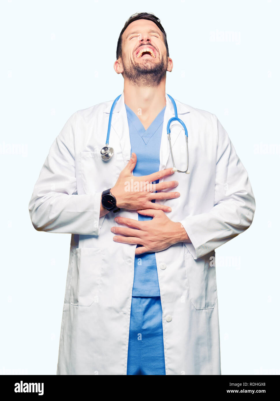 Handsome doctor man wearing medical uniform over isolated background ...