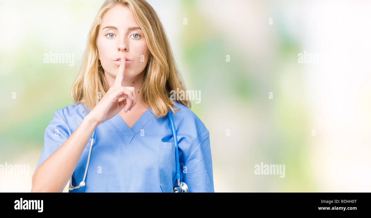 Beautiful young doctor woman wearing medical uniform over isolated ...